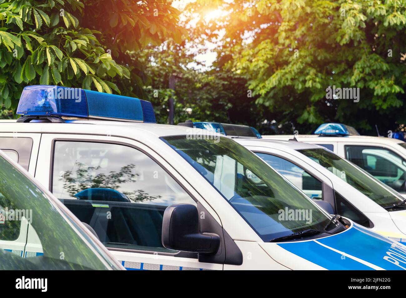 Close-up detail view of many german police van cars parked in raw on ...