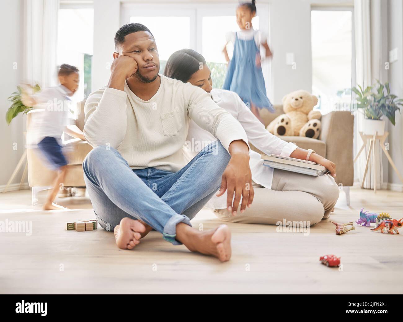 We need a getaway. Shot of two parents looking exhausted while their ...