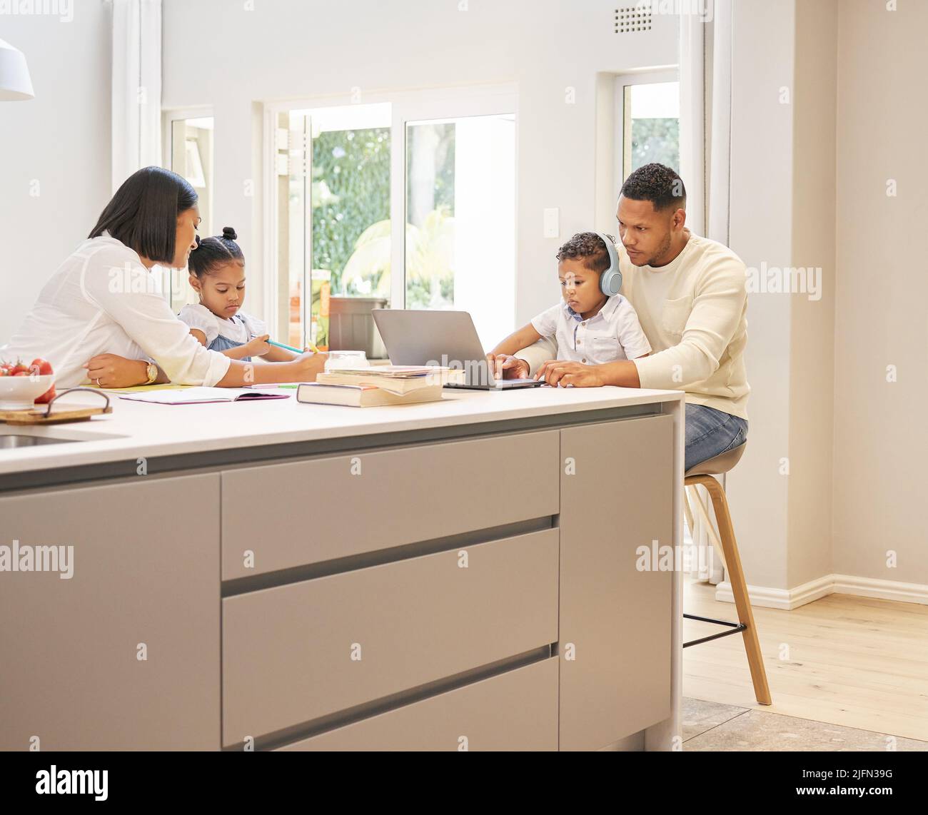Couple home schooling their two children. Distance online learning from ...