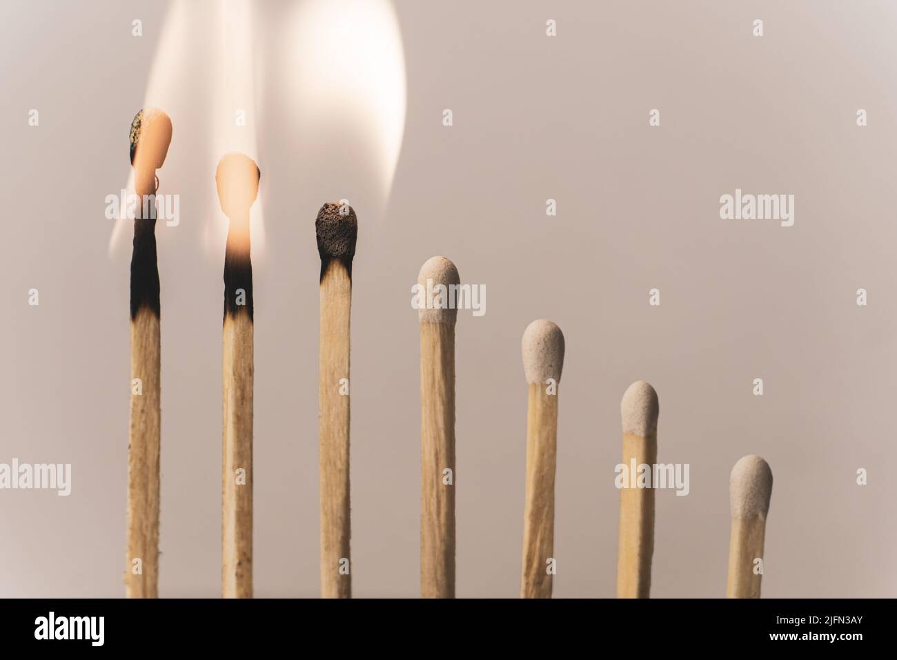 Matchsticks burning in sequence Stock Photo - Alamy