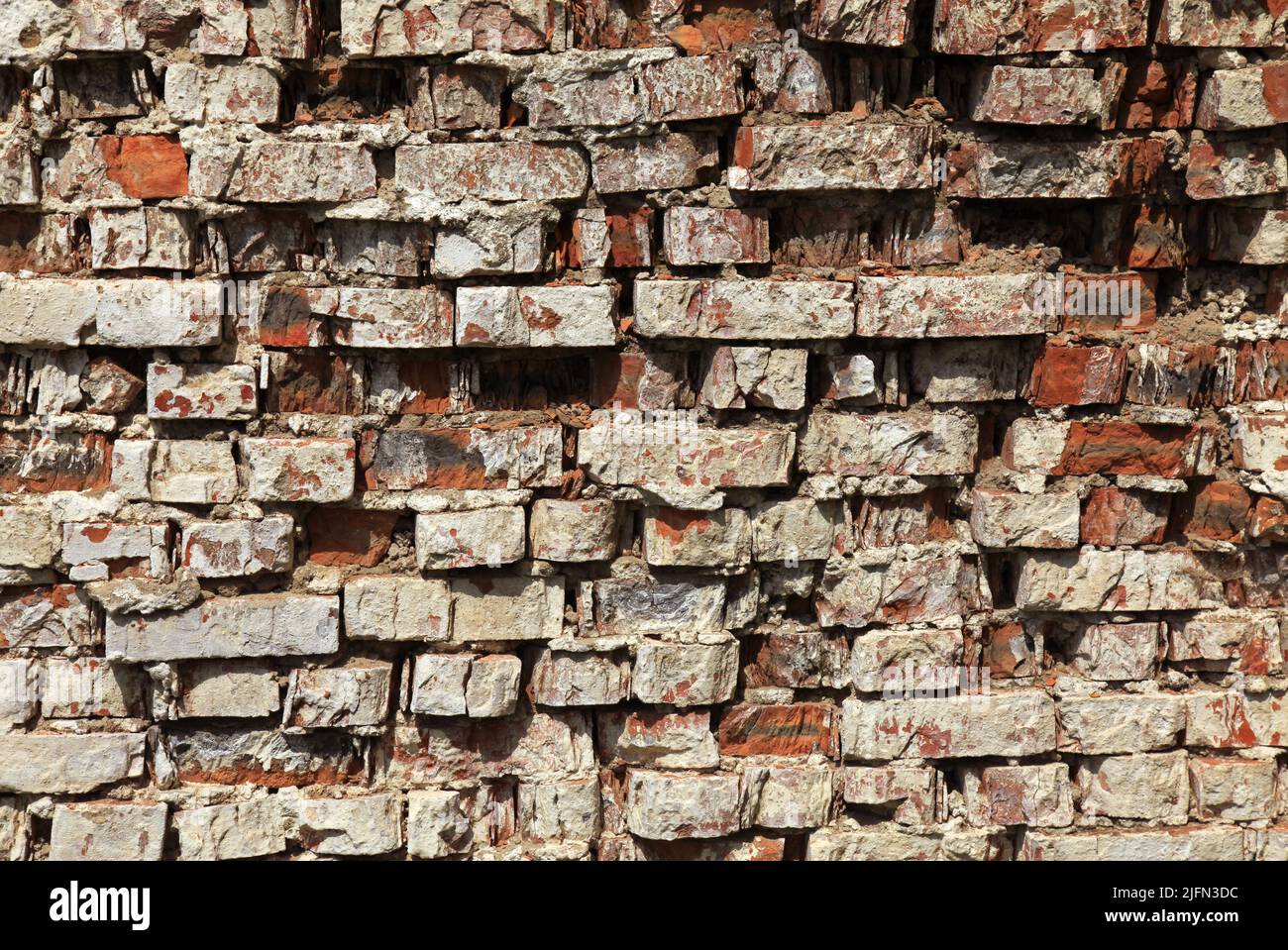 Old brick wall texture. The wall, made of old red bricks, darkened by ...