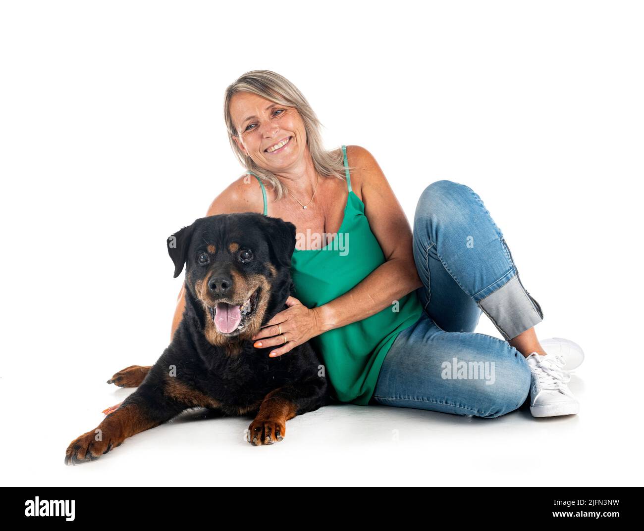 purebred old rottweiler fourteen year and his owner in front of white ...