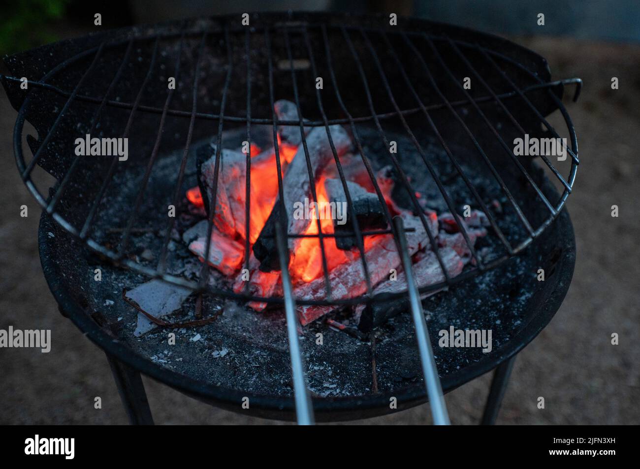 Barbecue lit with charcoal Stock Photo - Alamy
