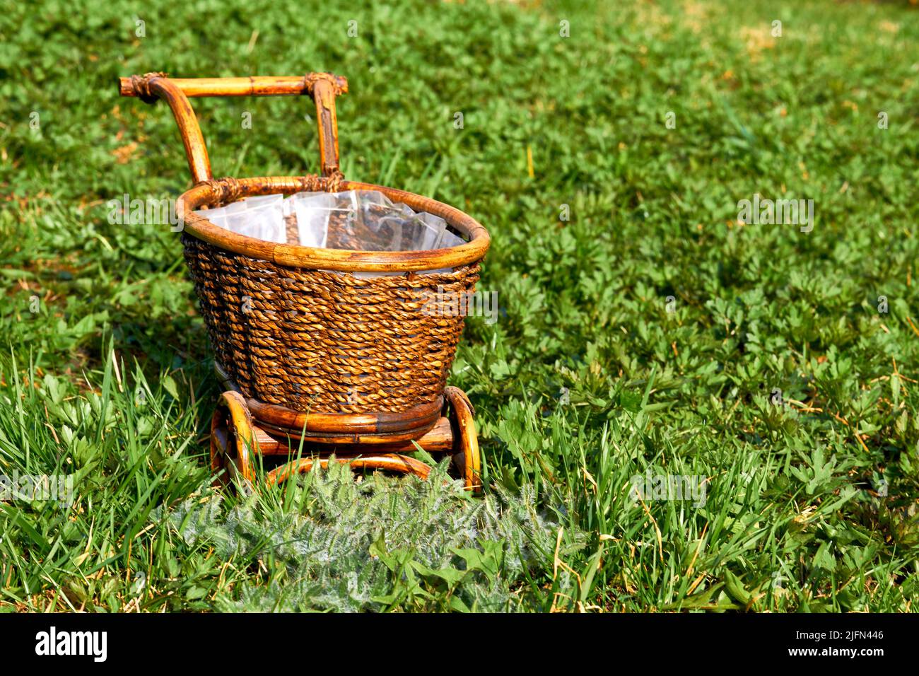 Wooden wicker brown cart in a garden on a green lawn Stock Photo - Alamy