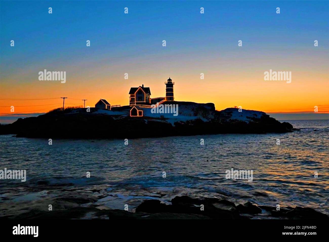 Nubble Lighthouse in the distance at Sunrise Stock Photo - Alamy