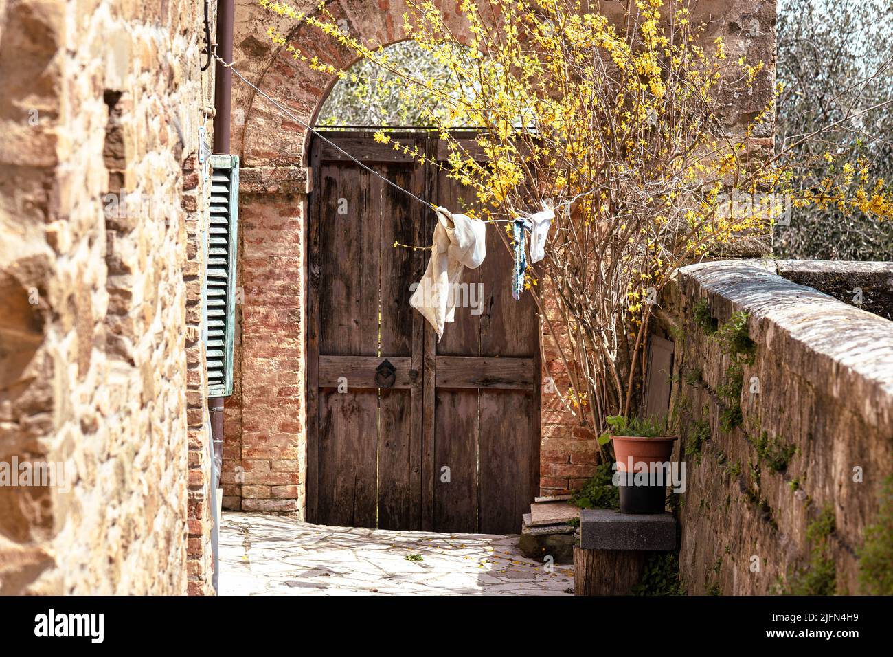 House entrance in Tuscany Italy with typical laundry line in front of ...