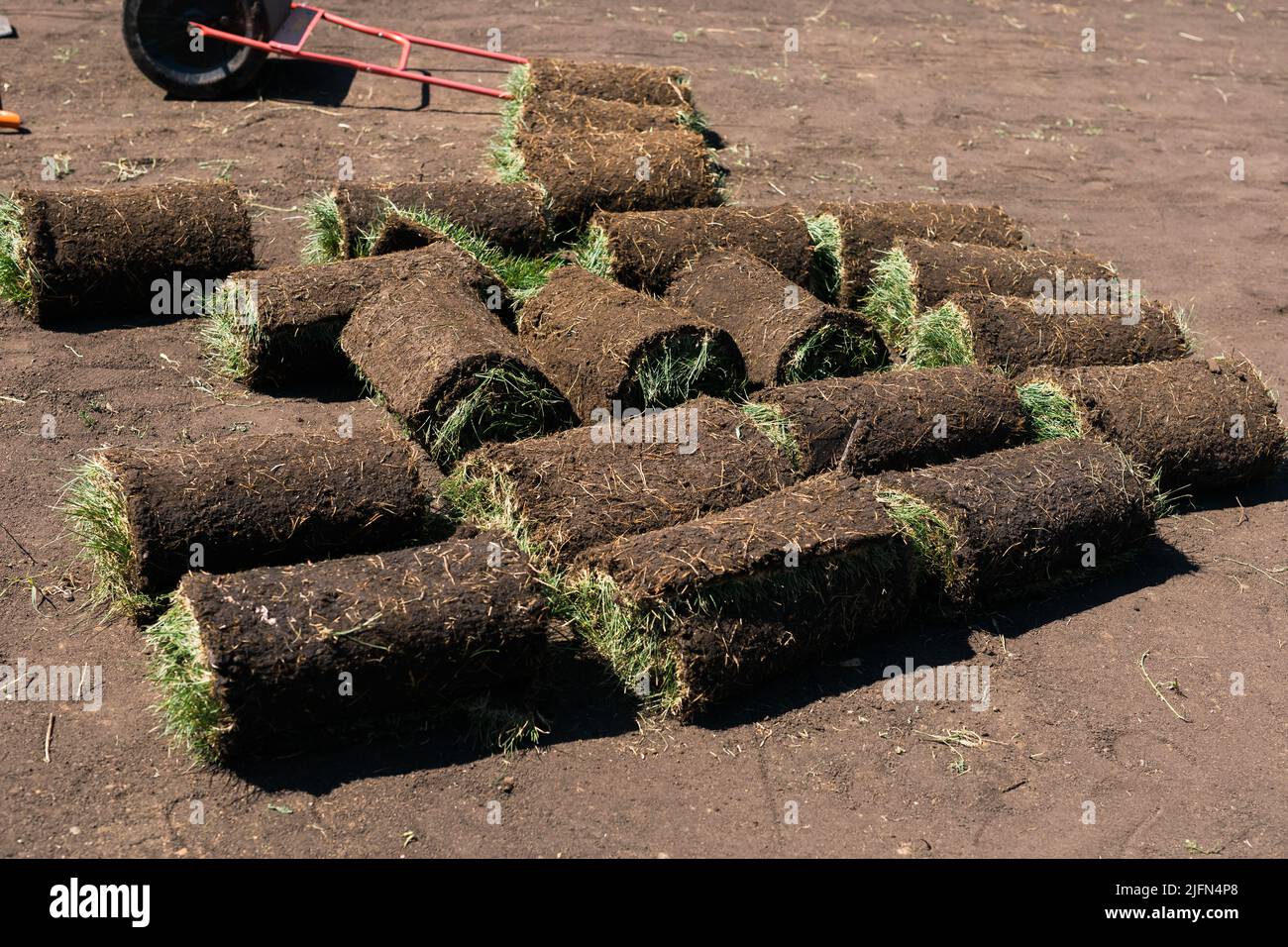 Installing new grass turfs from a roll - Garden building theme Stock ...
