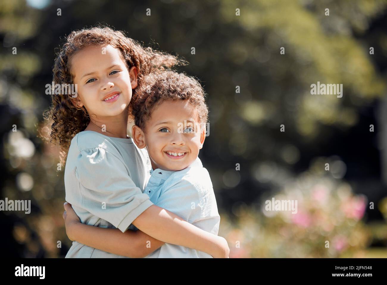 Portrait of a mixed race brother and sister smiling, standing and ...