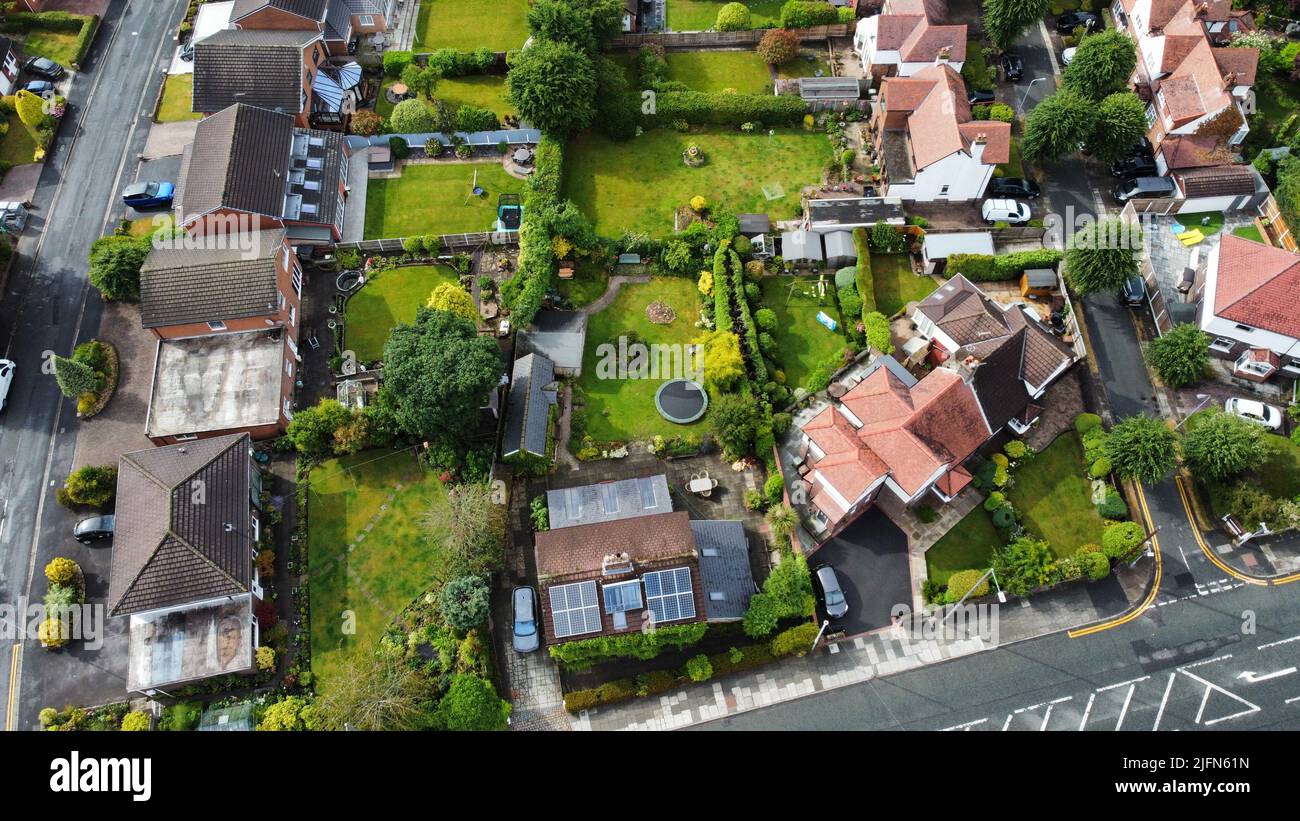 An aerial top view of suburbs with beautiful houses and green lawns ...