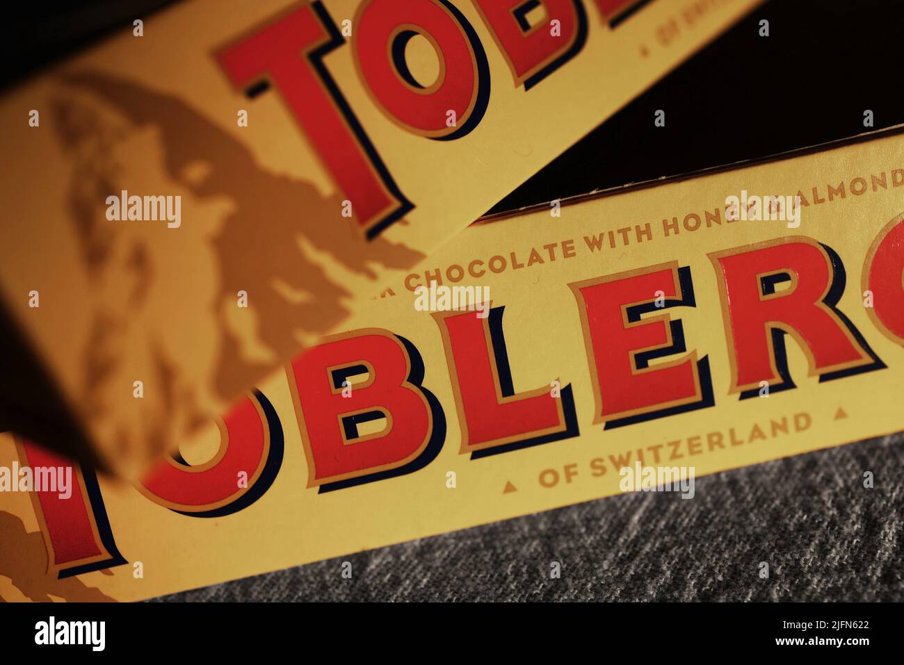 A Toblerone chocolate bar in the evening sun on a kitchen table in home ...