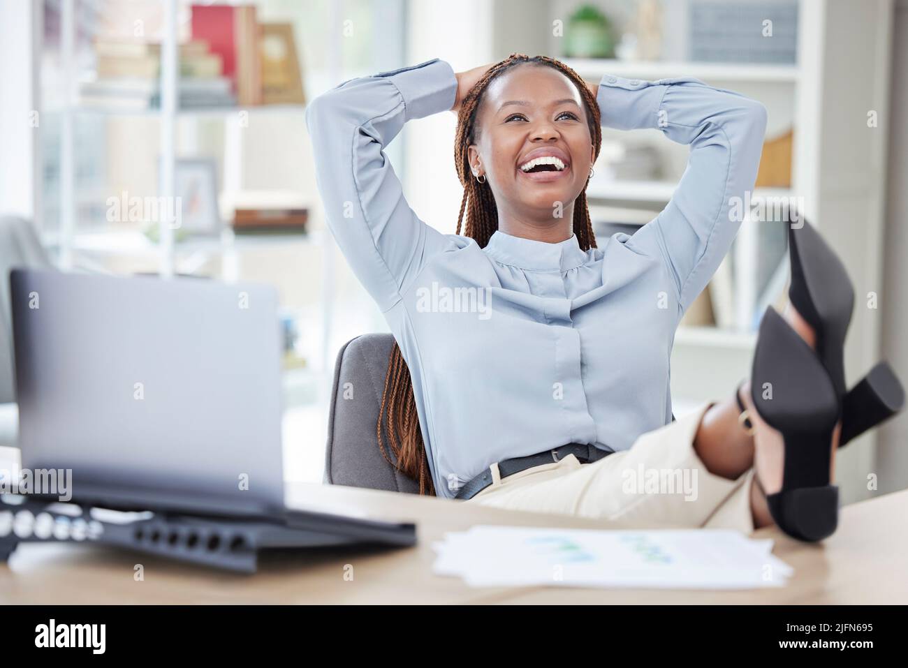 Business Woman relaxing with her feet on her desk. African american ...