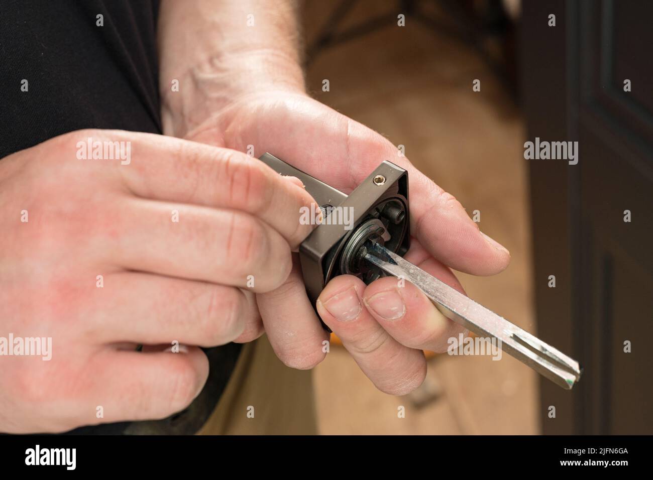 Handyman holding a doorknob and hex key, doorknob installation, metal ...