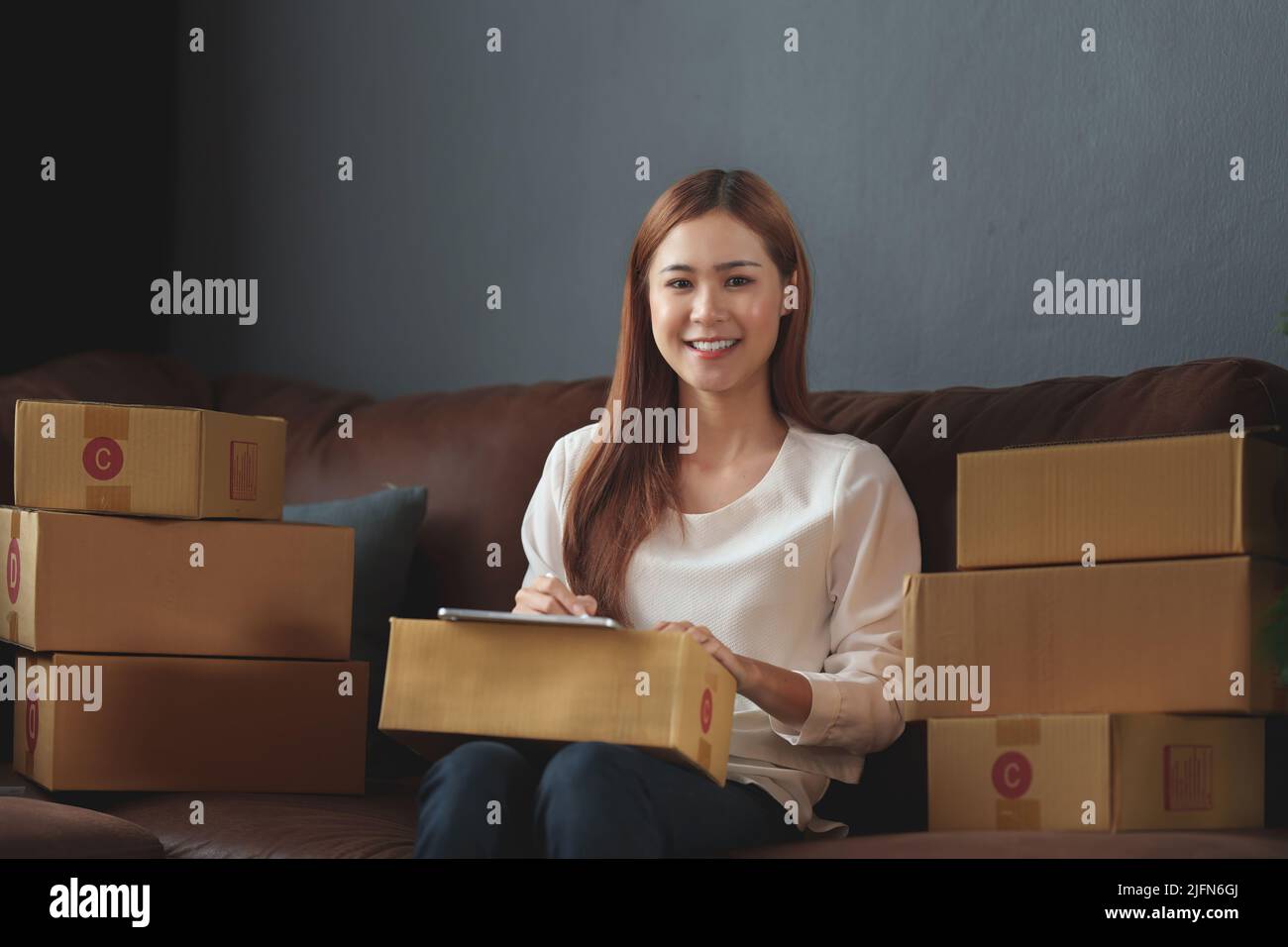 Image of Young asian woman startup freelance with parcel box and ...