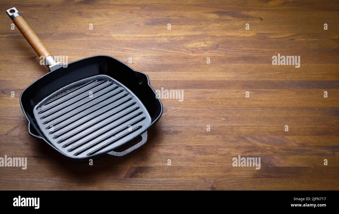 Empty grill pan for frying bbq closeup on wooden table, rustic style ...