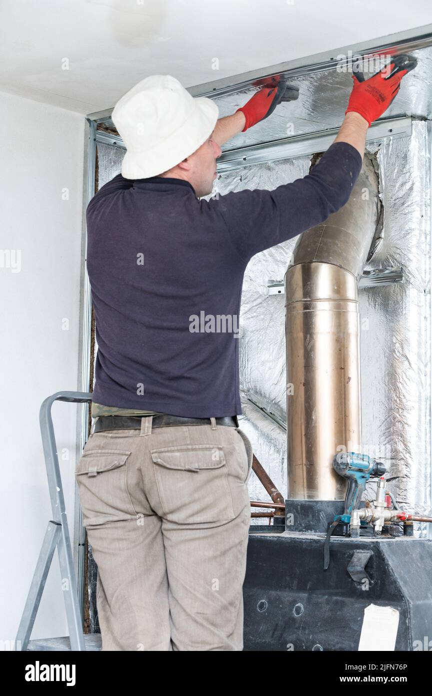 Installation of mineral wool with foil around the fireplace for thermal ...