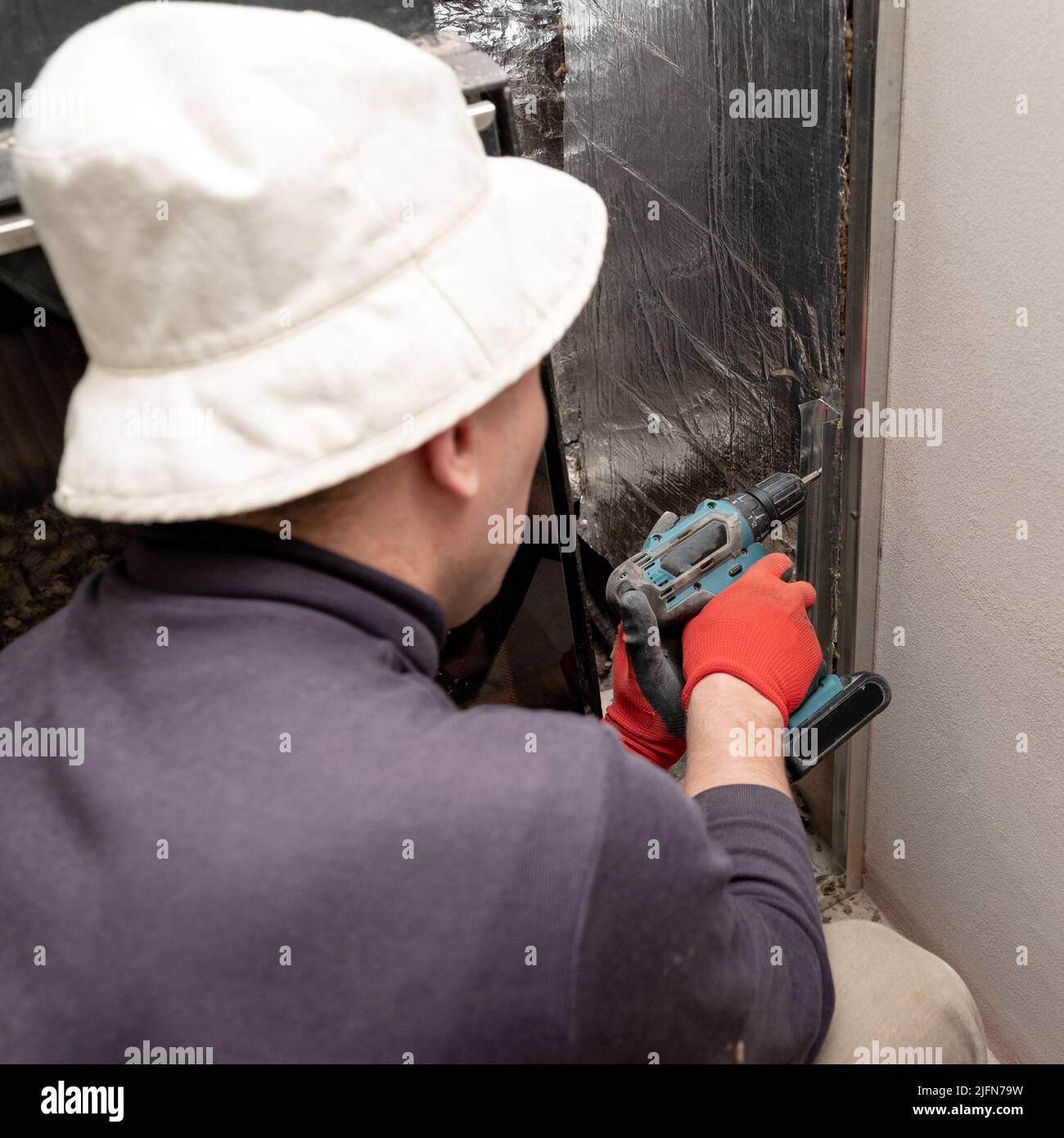 Installation of mineral wool with foil around the fireplace for thermal ...