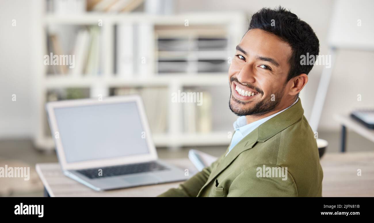 Portrait of one confident young mixed race businessman working on ...