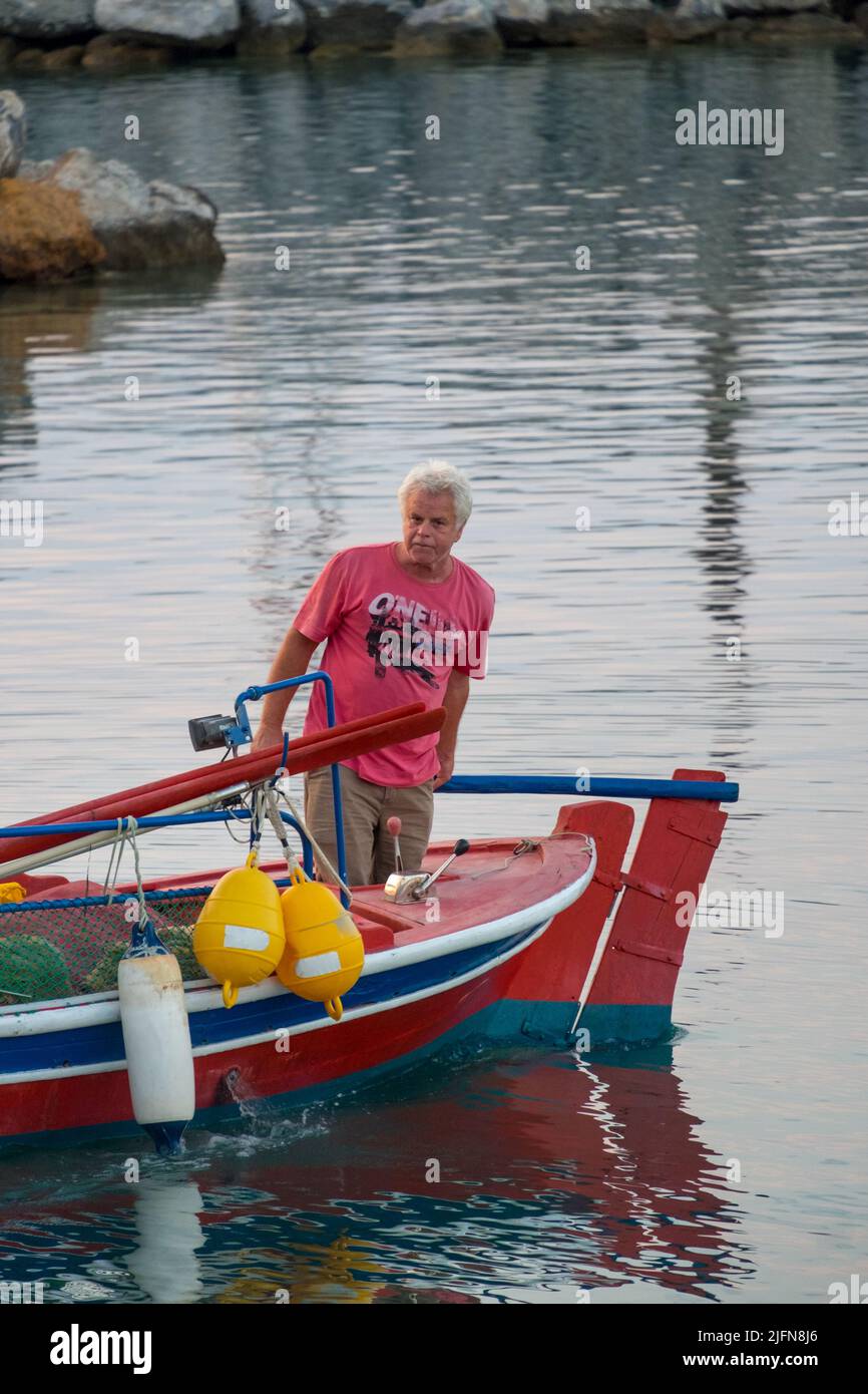 A fisherman heading out to the sea with hiw fishing boat Stock Photo ...