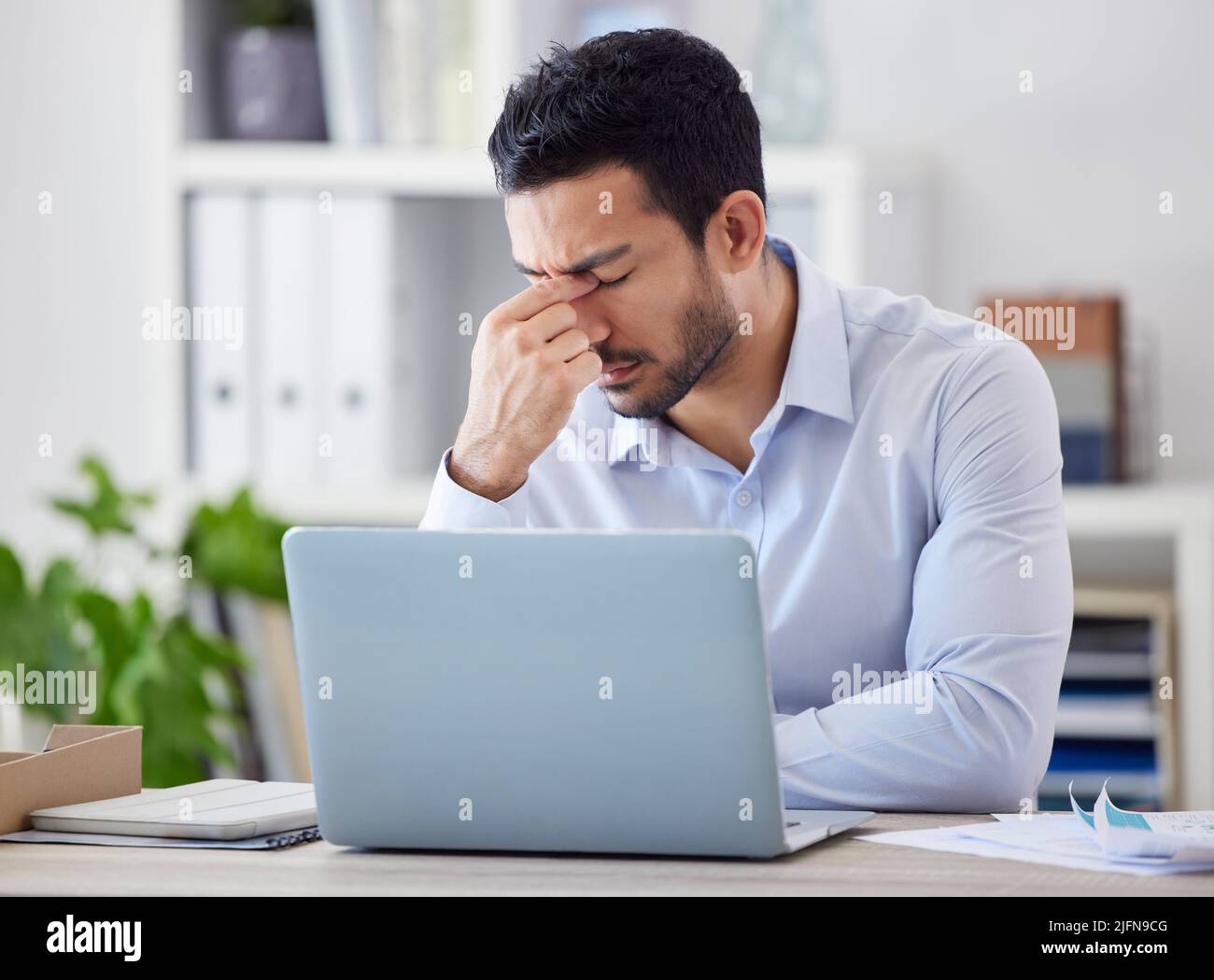 Stressed asian businessman working on laptop. Frustrated professional ...