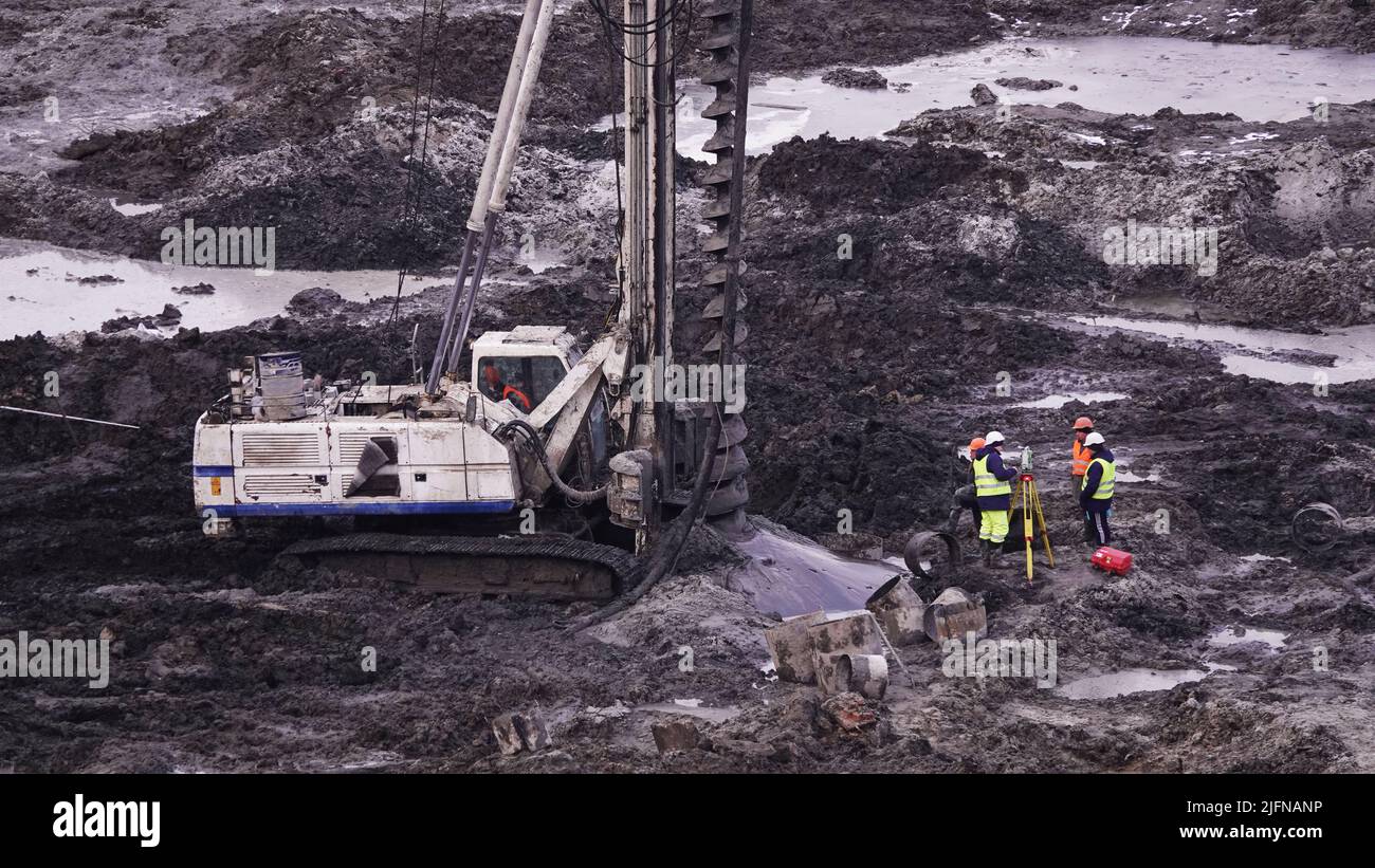 Kiev, Ukraine, October 17, 2018: Workers in the mud of a construction ...