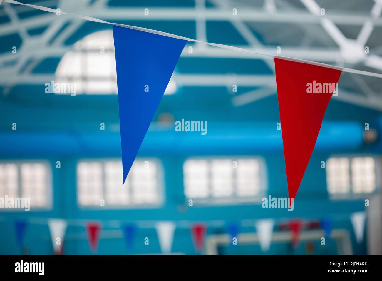A blue and red color bandits hanging inside a hall Stock Photo - Alamy