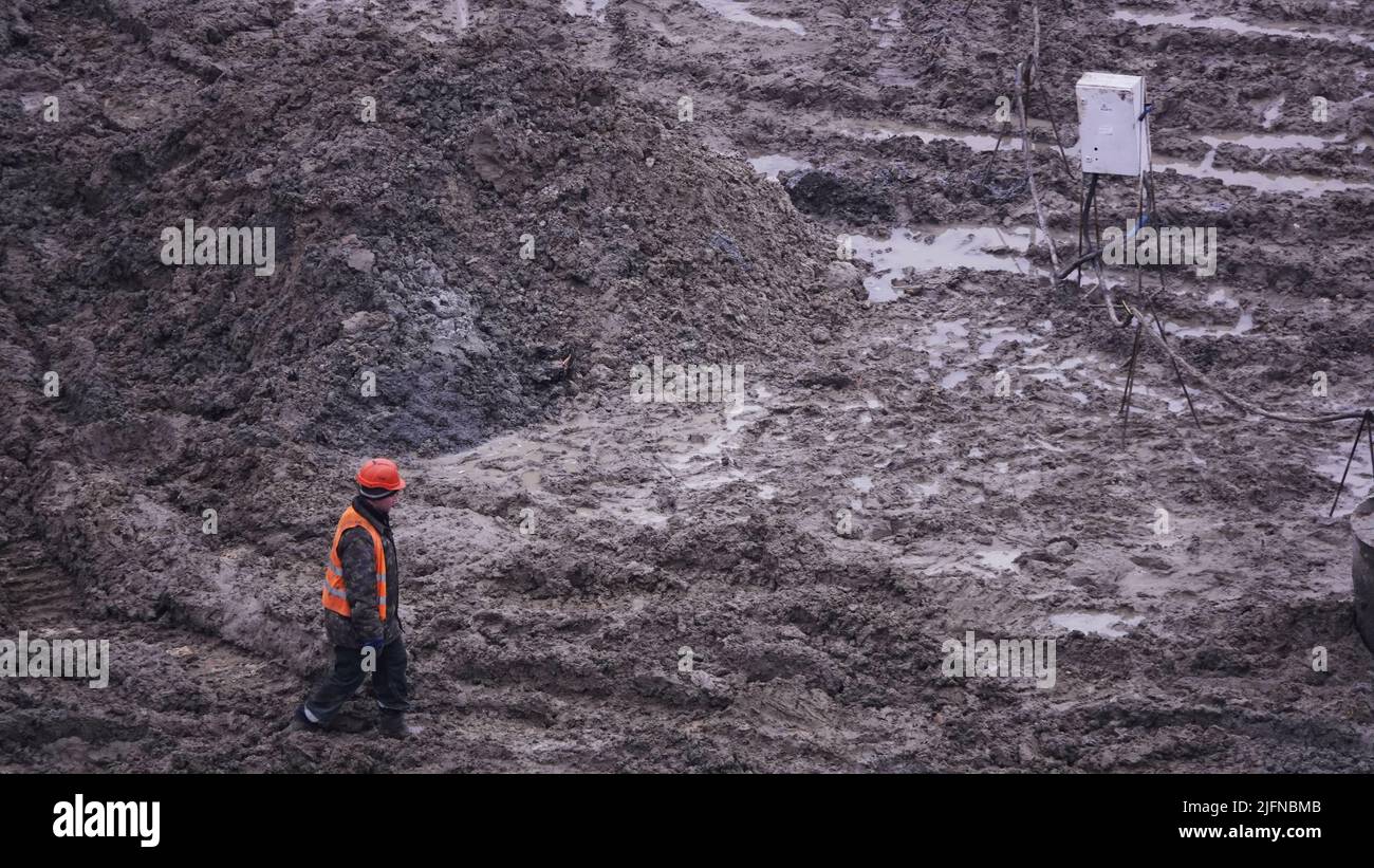 Kiev, Ukraine, October 17, 2018: Workers in the mud of a construction ...