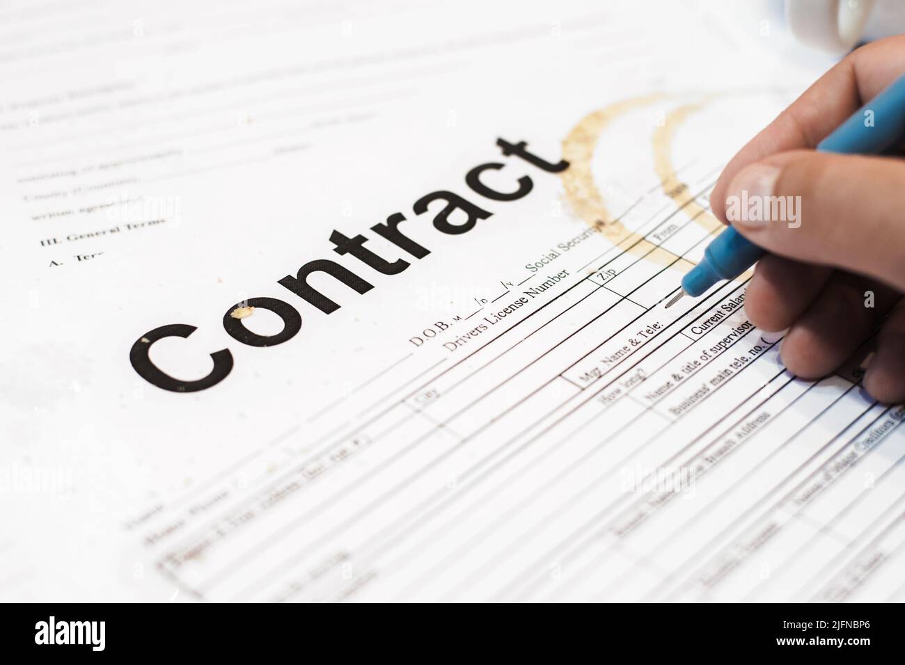 Contract papers with cracker and coffee trace Stock Photo - Alamy