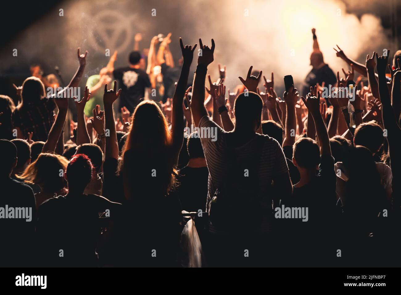 Crowd at concert - Cheering crowd in bright colorful stage lights Stock ...