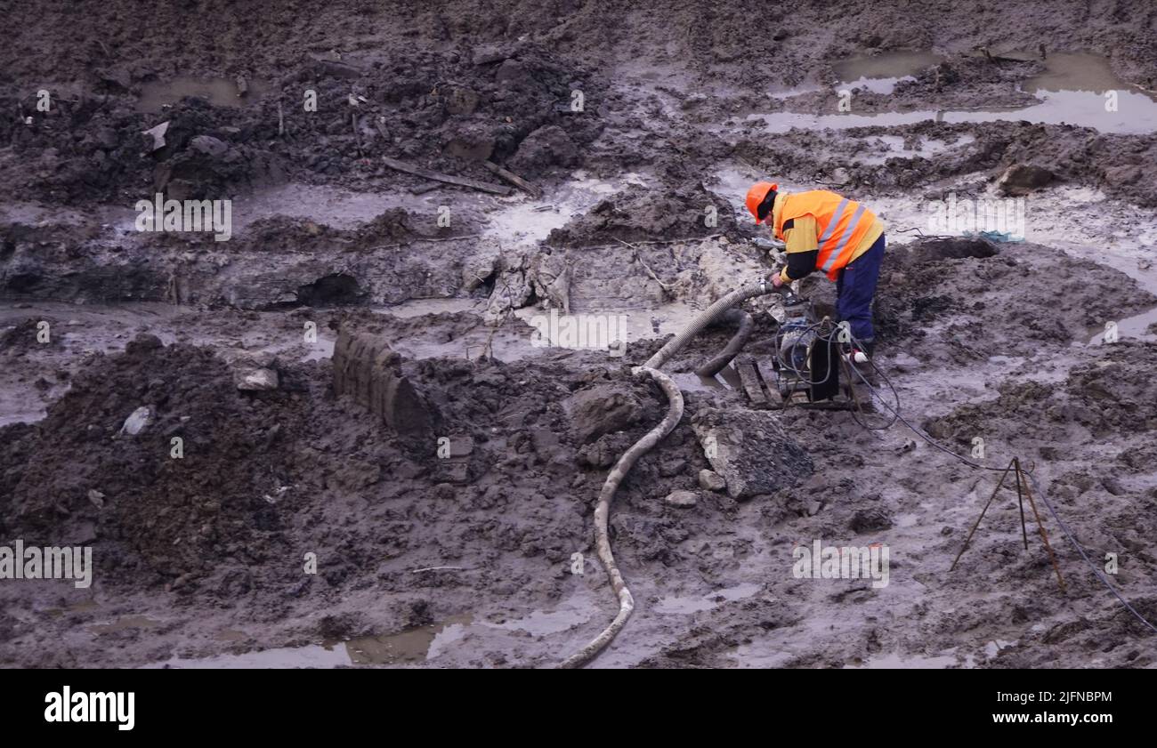 Kiev, Ukraine, October 17, 2018: Workers in the mud of a construction ...