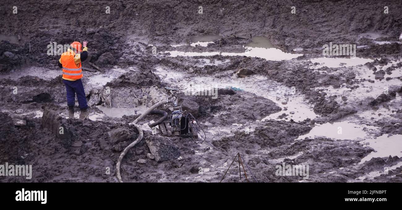 Kiev, Ukraine, October 17, 2018: Workers in the mud of a construction ...