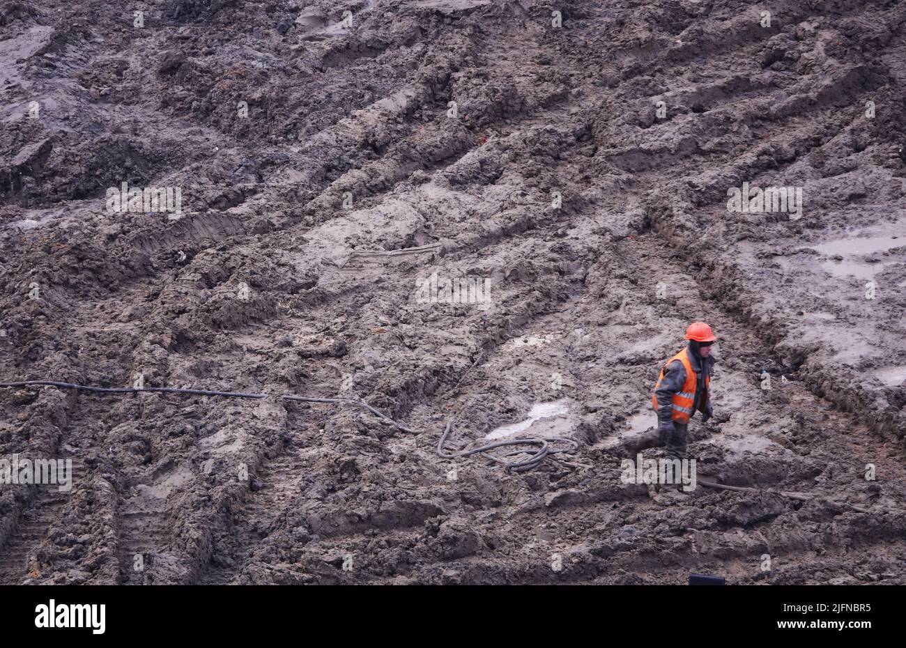 Kiev, Ukraine, October 17, 2018: Workers in the mud of a construction ...