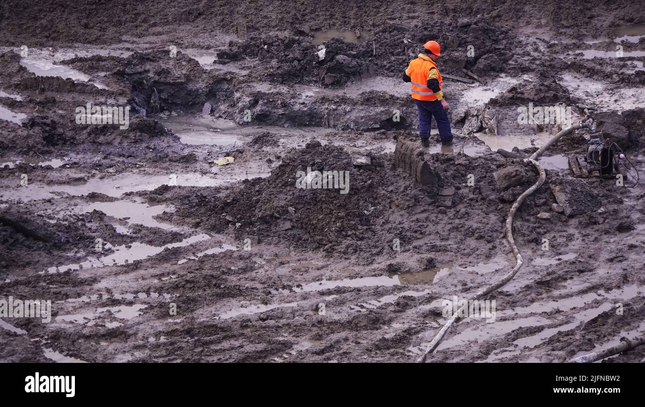 Kiev, Ukraine, October 17, 2018: Workers in the mud of a construction ...