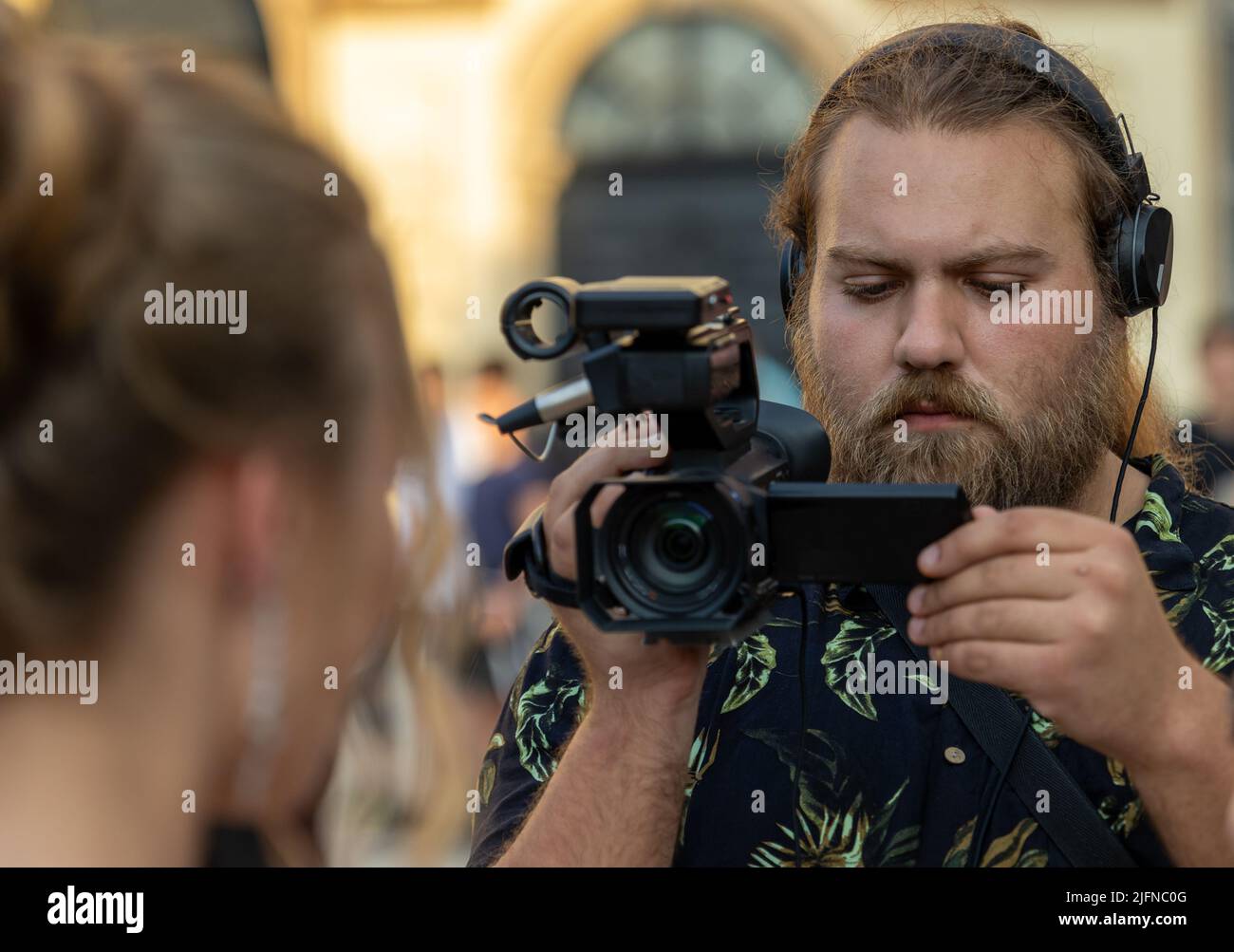 Young man recording event with camera. Behind the scene concept Stock ...