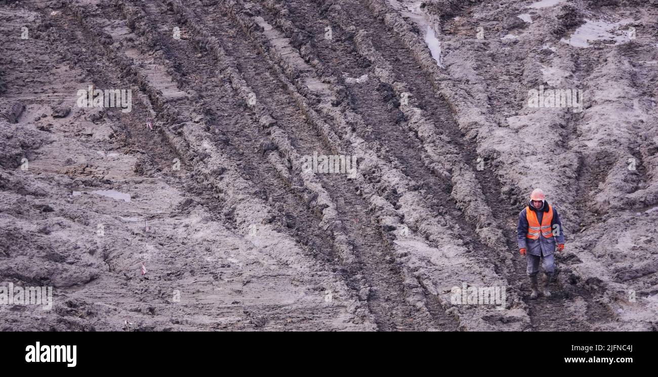 Kiev, Ukraine, October 17, 2018: Workers in the mud of a construction ...
