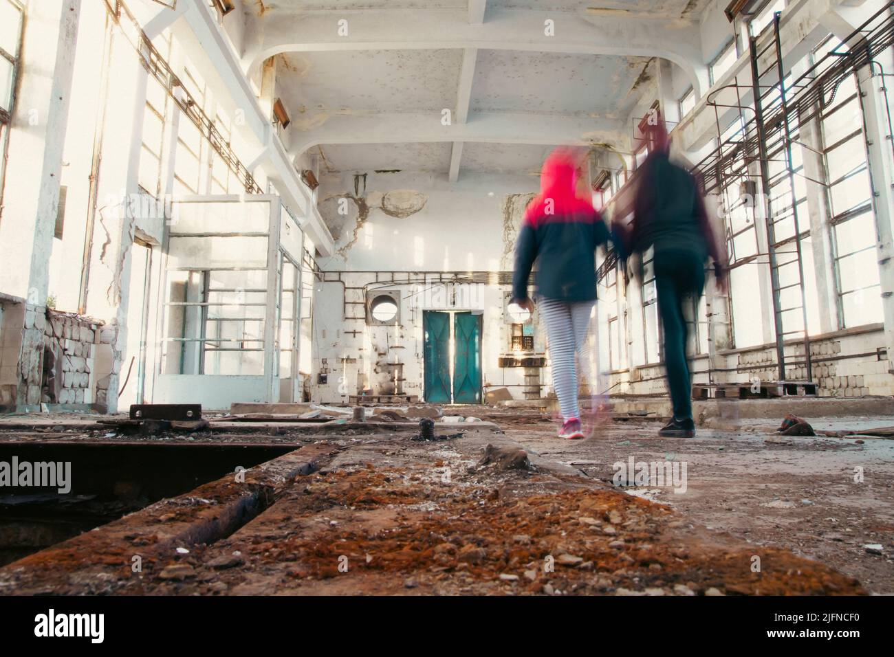 Mother and daughter refugees walking with hope together holding hands ...