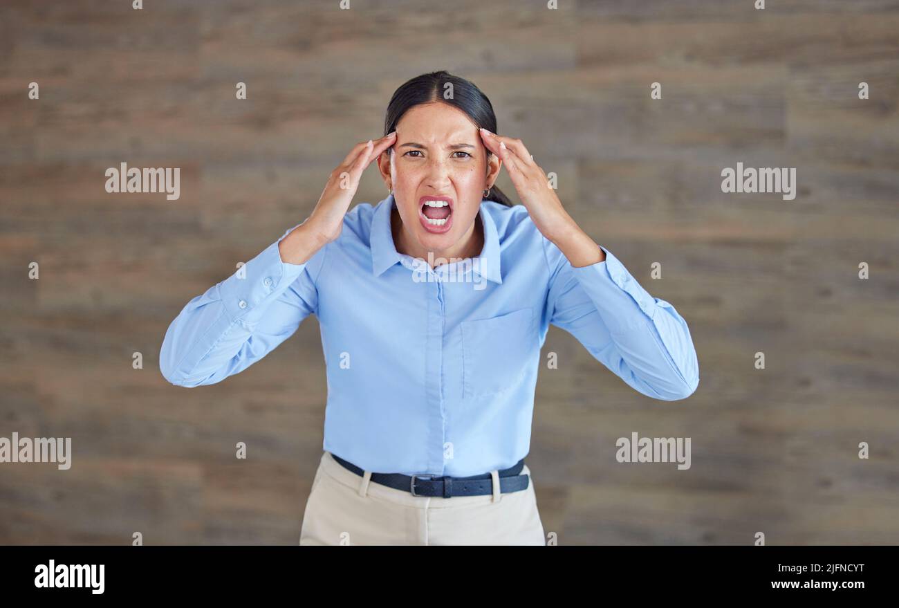 Young mixed race woman looking angry and annoyed while screaming and ...