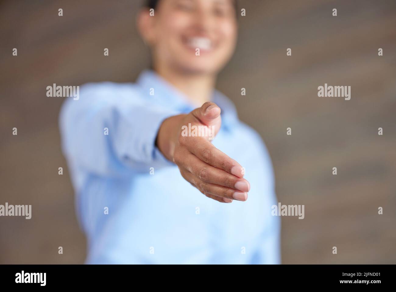 Closeup of a businesswoman giving a handshake. Female employee reaching ...