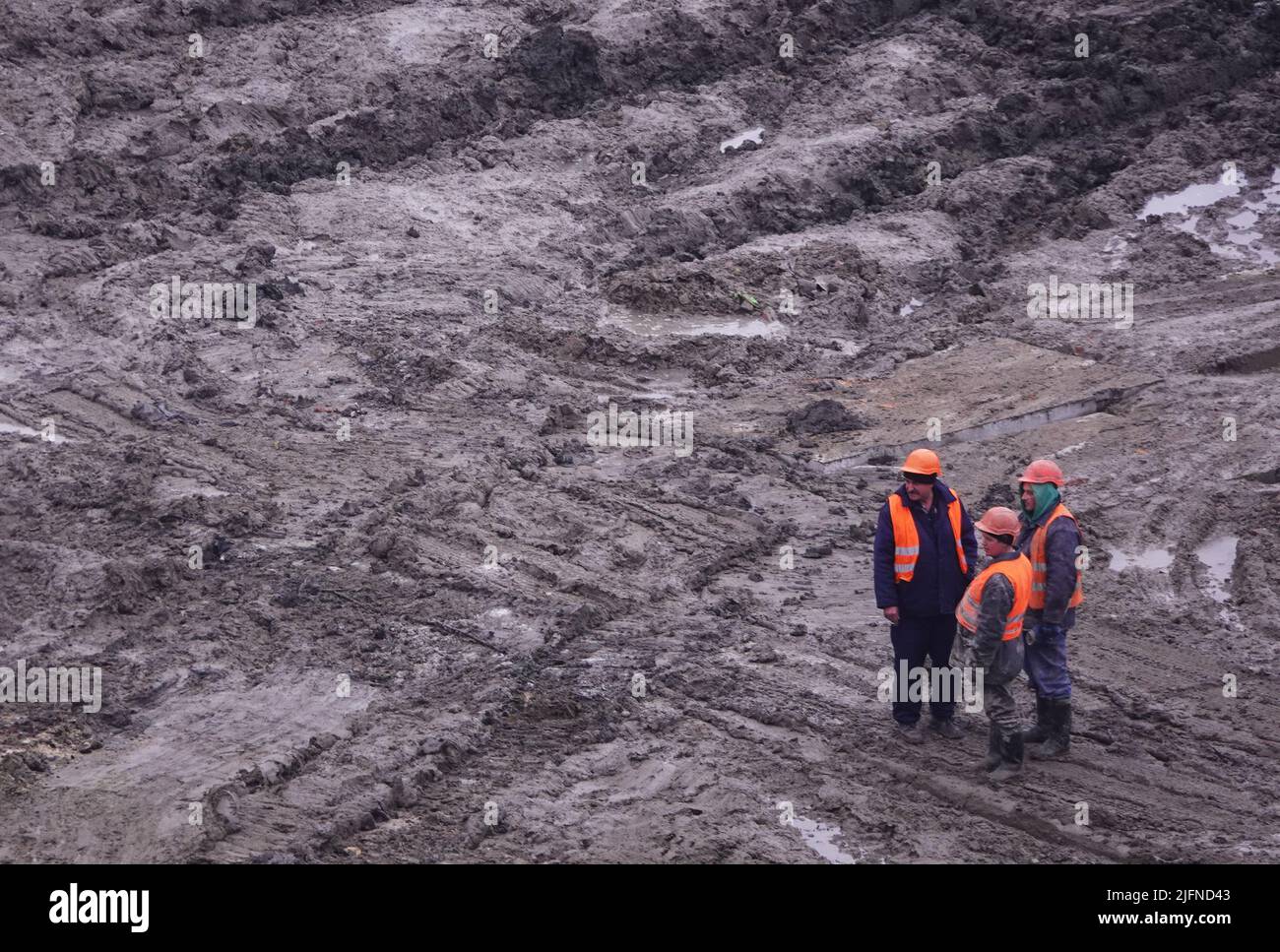 Kiev, Ukraine, October 17, 2018: Workers in the mud of a construction ...