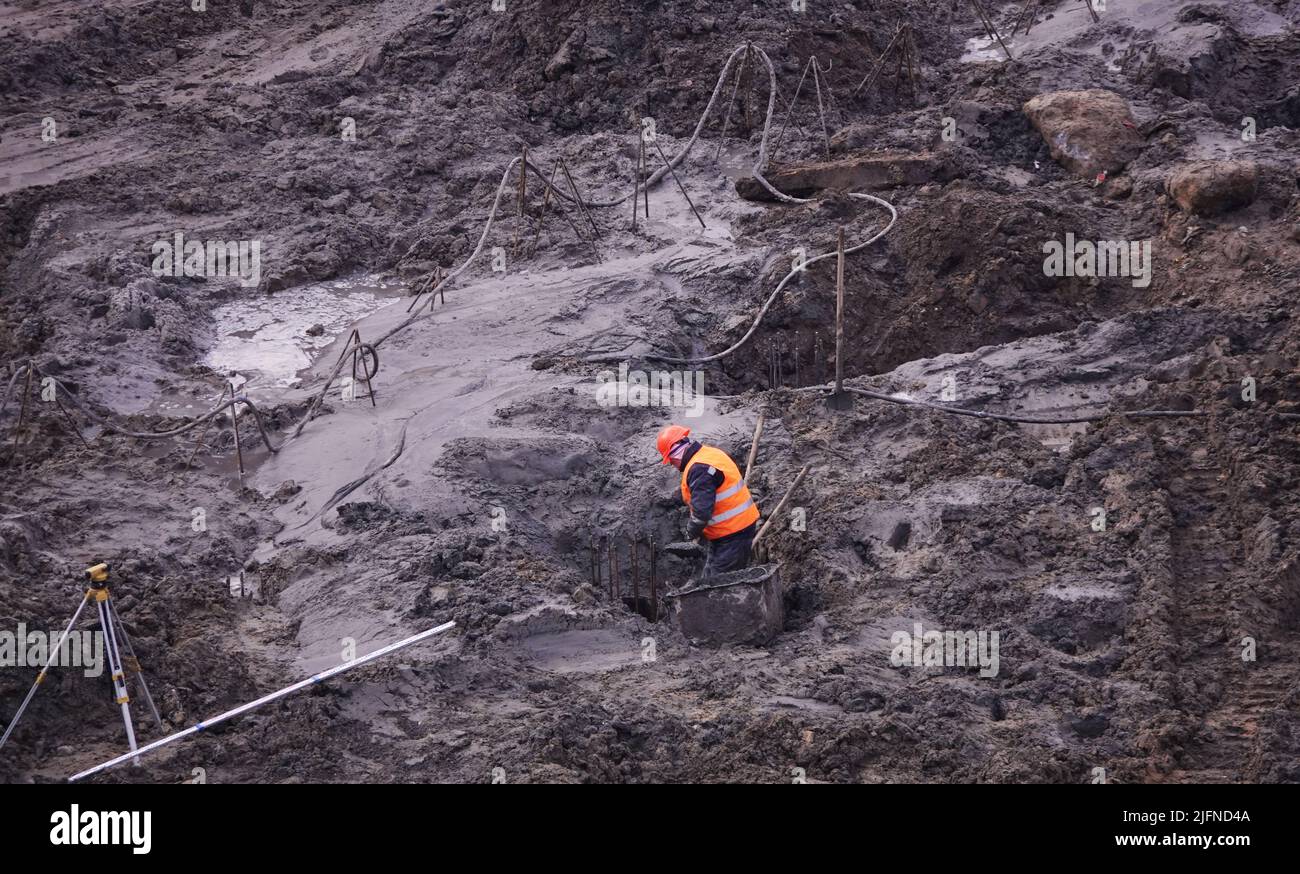 Kiev, Ukraine, October 17, 2018: Workers in the mud of a construction ...