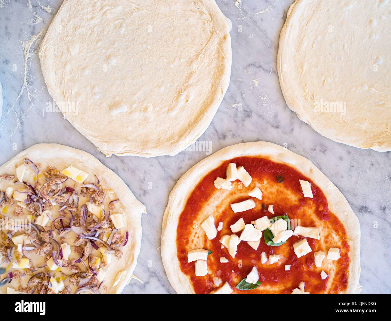 background photo of some pizzas on marble top with flour and ...