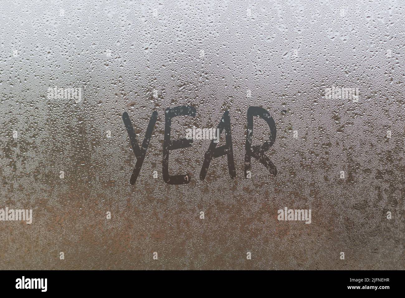Word year written on foggy window, closeup view Stock Photo - Alamy