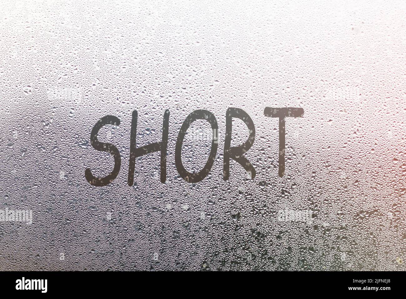 Foggy glass on window with written finger word short Stock Photo - Alamy