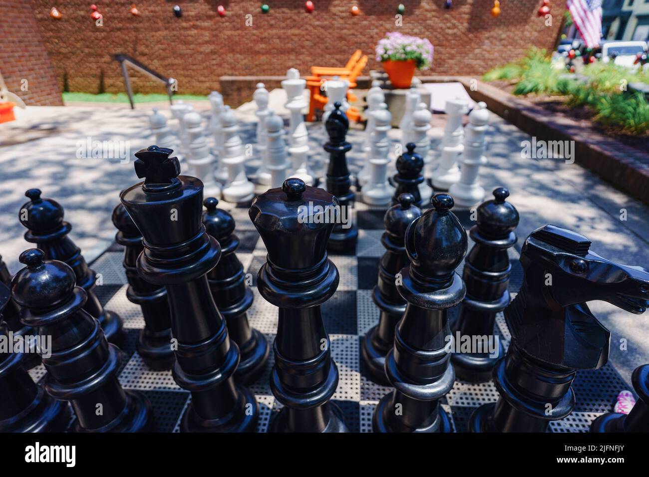 A large outside chess set awaits strategic thinking challengers at a ...