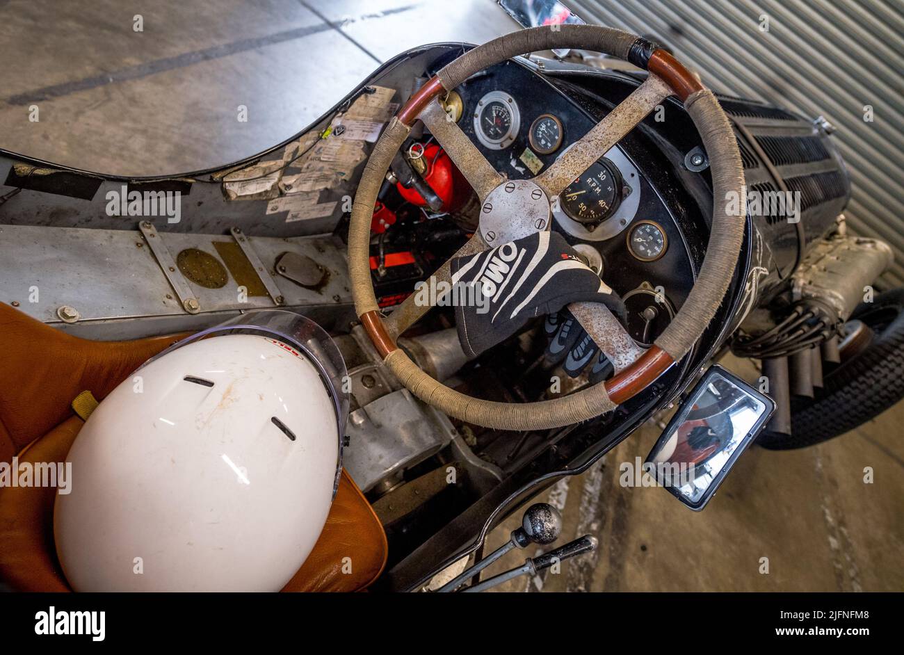 Vintage car drivers seating position, steering wheel, seat, glovers and ...