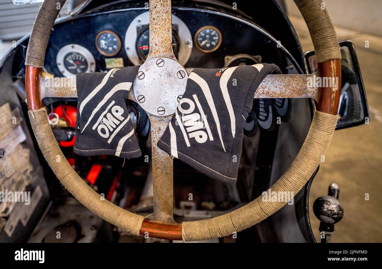 Vintage car drivers seating position, steering wheel, seat and glovers ...