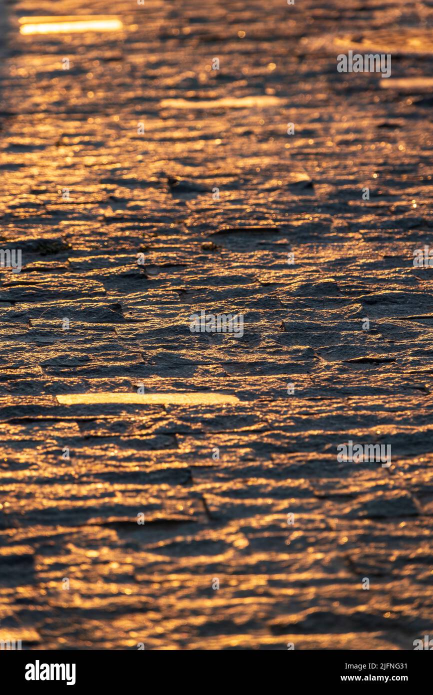 Stone pavement in the rays of the setting sun. Backround of Block ...