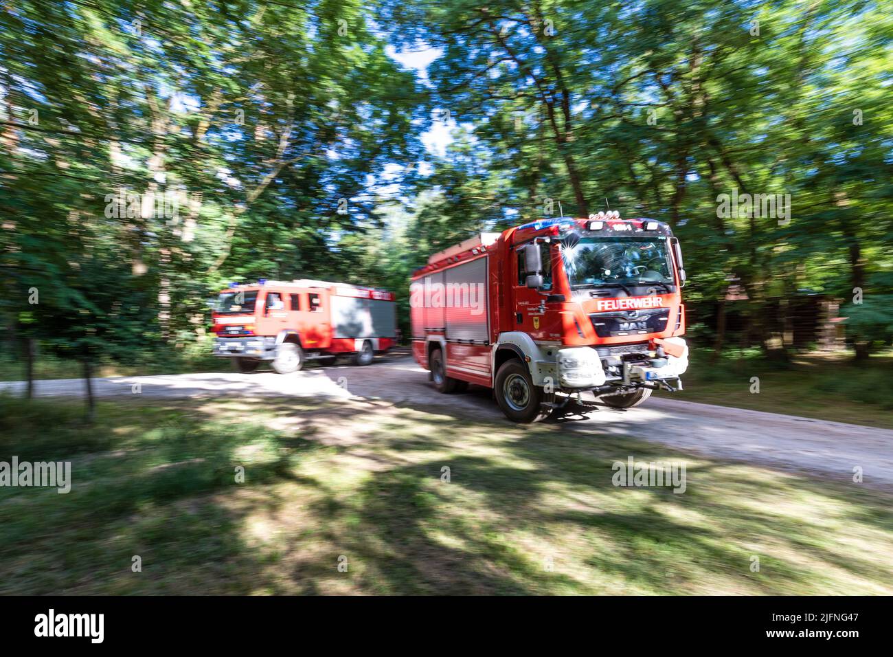 Byhlen, Germany. 04th July, 2022. Fire department vehicles drive ...