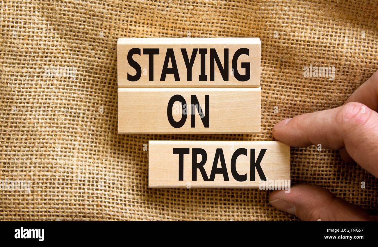 Staying on track symbol. Concept words Staying on track on wooden ...