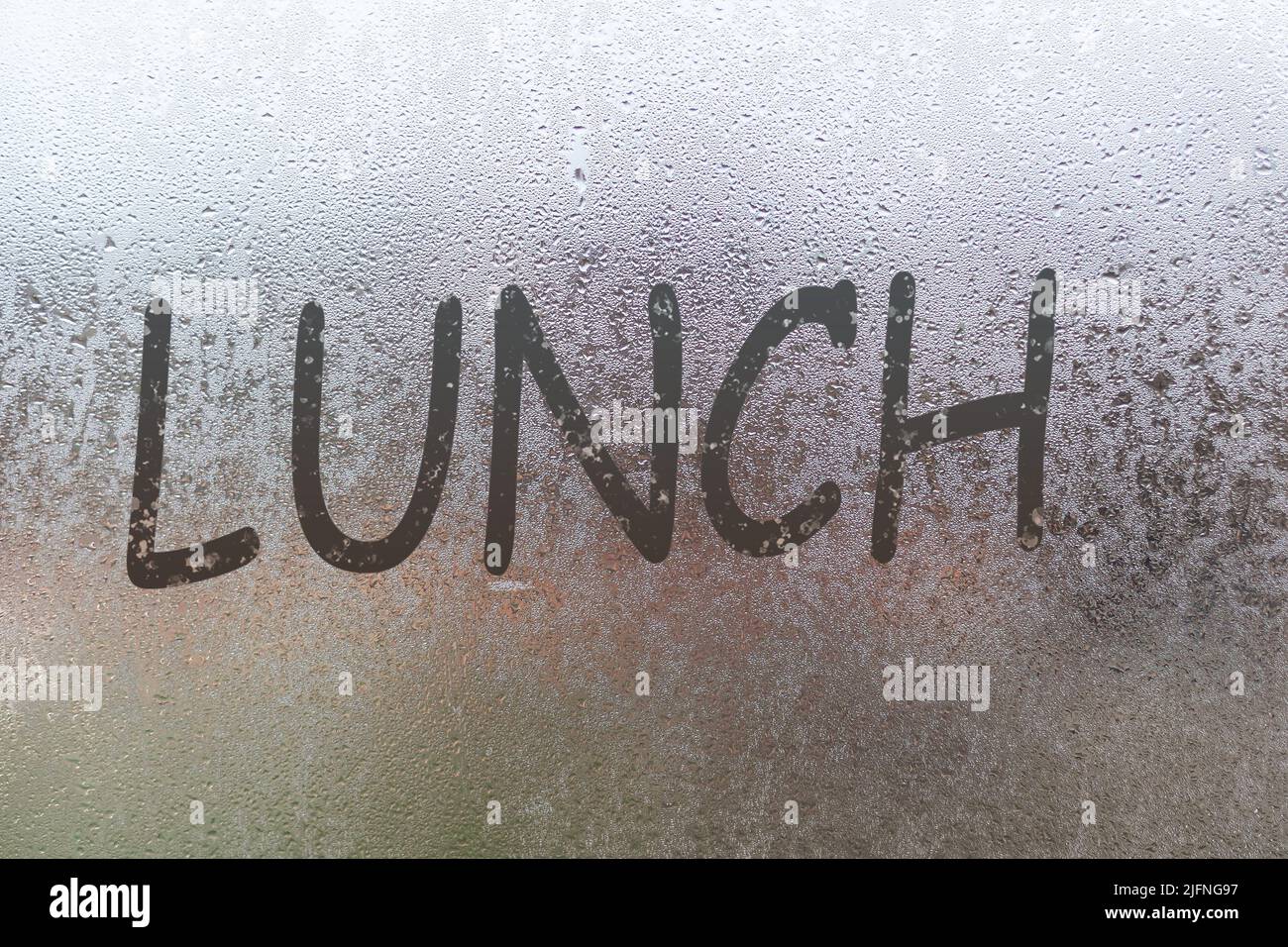 The word lunch written on the sweaty glass of the window Stock Photo ...