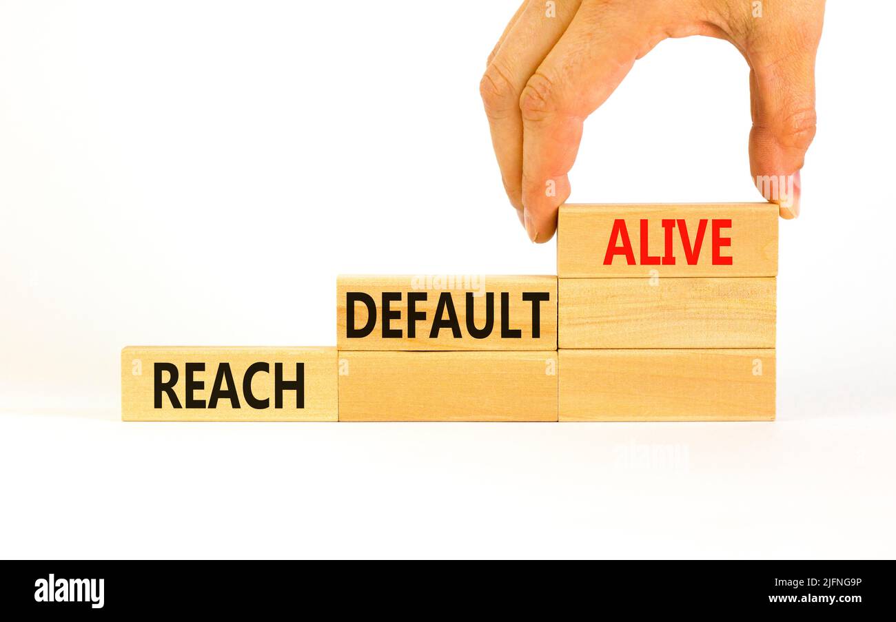 Reach default alive symbol. Concept words Reach default alive on wooden ...